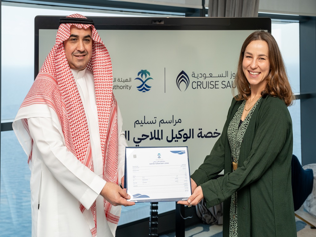 Mohammed Bukhari hands over the licence to Barbara Buczek